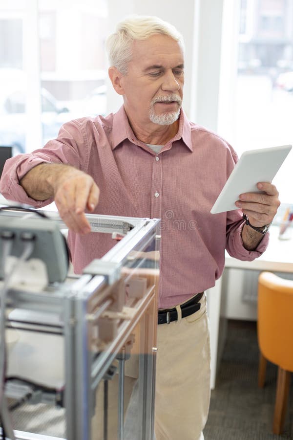 Charming Senior Man Reading 3D Printer Manual from Tablet Stock Image ...