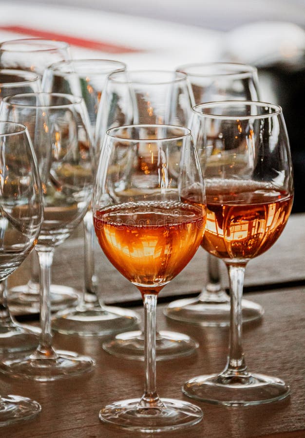 Two Wine Glasses Filled with Wine and Empty Glasses Ready for Refills ...