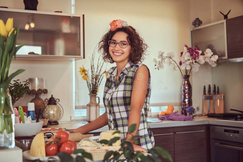 Charming Curly Hispanic Girl Cooking in Her Kitchen. Stock Image ...