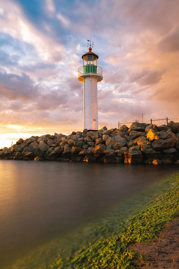 Charming Sunset Scene with a View of Old Lighthouse Stock Image - Image ...