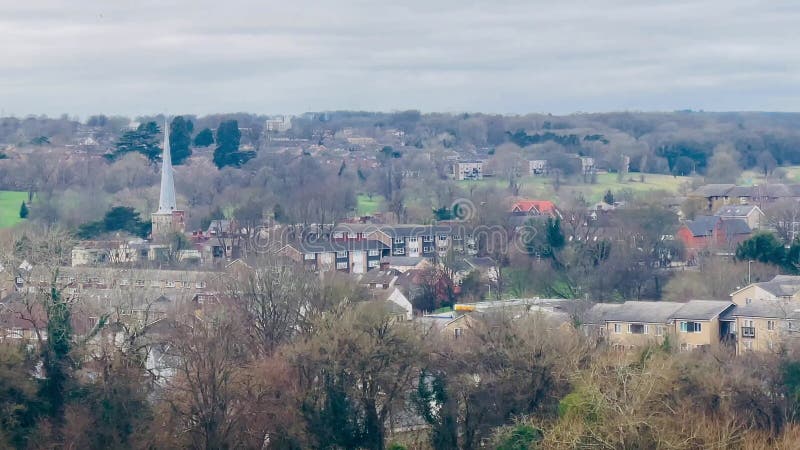 Charming Townscape View Framed by Tree Branches, Prominent Church Spire ...