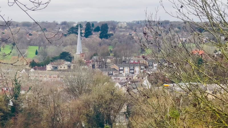 Charming Townscape View Framed by Tree Branches, Prominent Church Spire ...