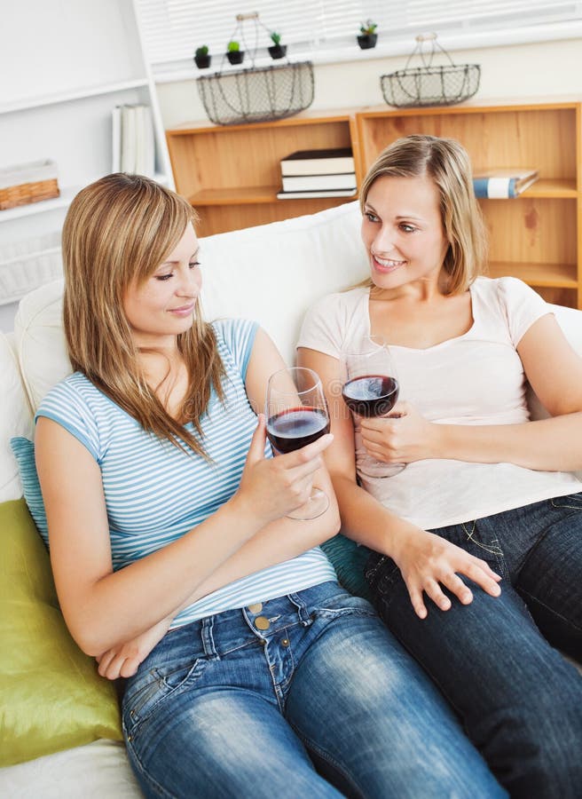Charming Two Women Drinking Wine Sitting on a Sofa Stock Image - Image ...