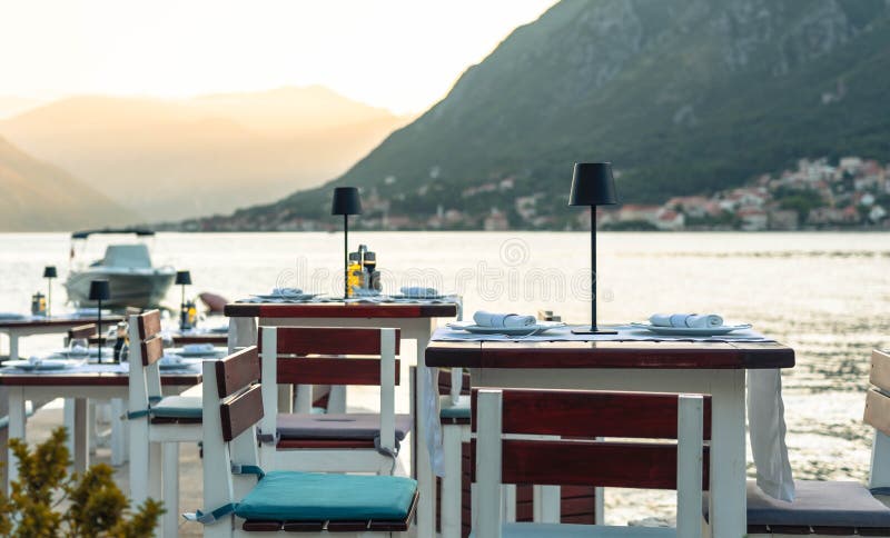 A Charming Waterfront Dining Setup with Mountain Views, Perfect for a ...