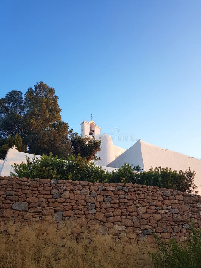 Traditional Whitewashed Church with Rustic Stone Wall Stock Image ...
