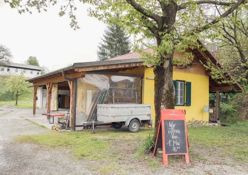 Charming Yellow Building with Truck and Chalkboard Sign in a Tranquil ...