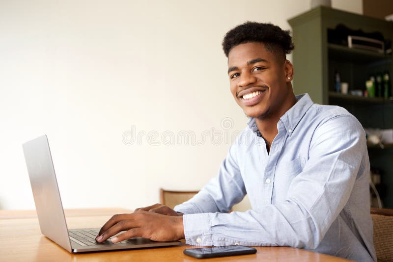 Man on Laptop Computer and Talking on Phone Stock Image - Image of ...