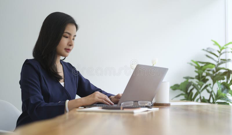 Charming Young Asian Businesswoman Sitting in Bright Modern Office and ...