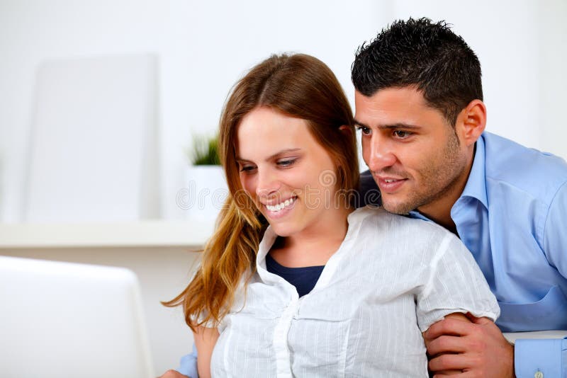 Charming Young Couple Browsing Internet on Laptop Stock Image - Image ...