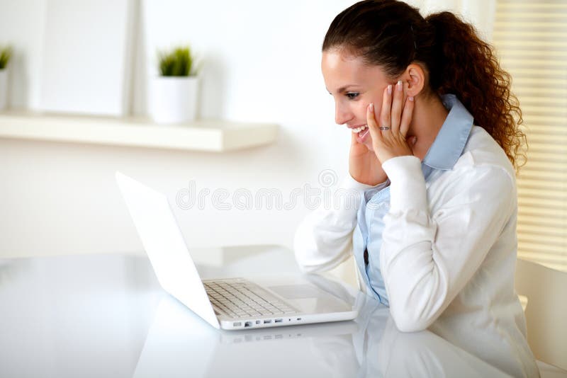 Charming Young Woman Reading on Laptop Screen Stock Photo - Image of ...