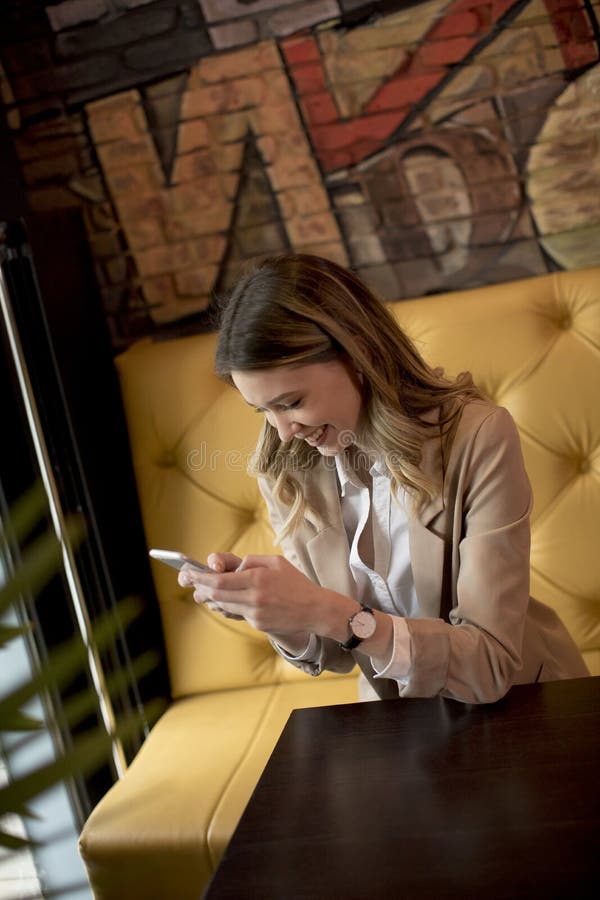 Young Woman Using Mobile Phone in the Cafe Stock Image - Image of ...