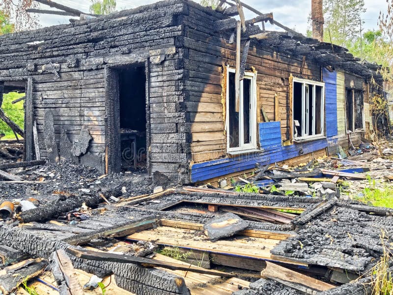 Charred Remains of a Wooden House after a Devastating Fire in a ...