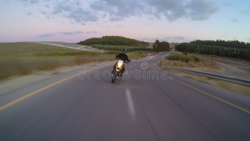 Chase View of a Fast Motorcycle Driving on a Curved Road Stock Video ...