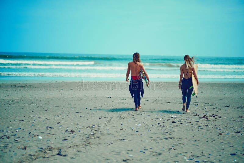 Chasing Waves is Our Top Priority. a Young Couple Walking on the Beach ...