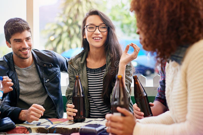 Chatting Over a Cold One. a Group of Friends Hanging Out and Drinking ...