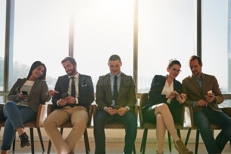 Chatting while they Wait. a Group of Businesspeople Sitting in Line ...