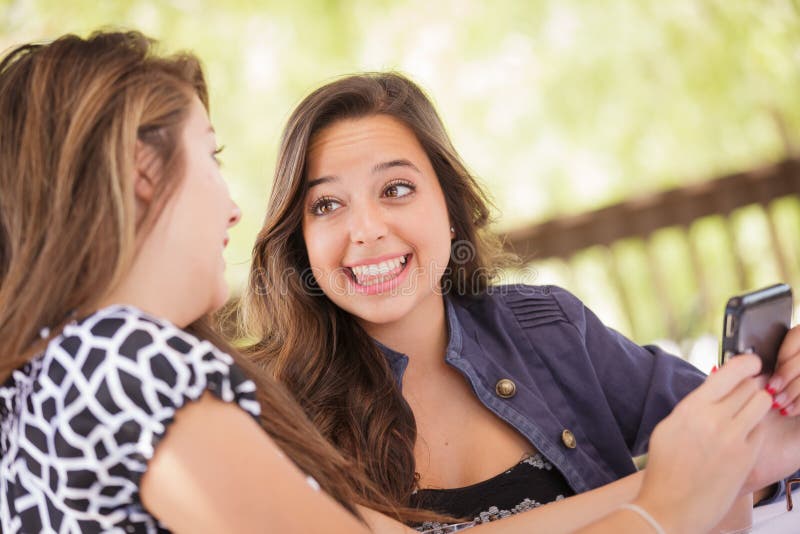 Chatty Young Adult Girlfriends Using Their Smart Phone Stock Photo ...