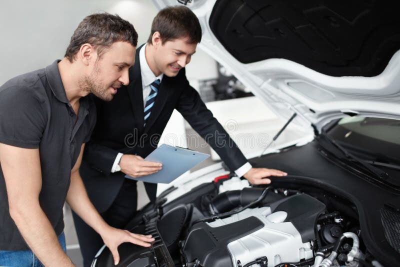 Dealer and Young Man with Auto in Car Dealership Stock Image - Image of ...