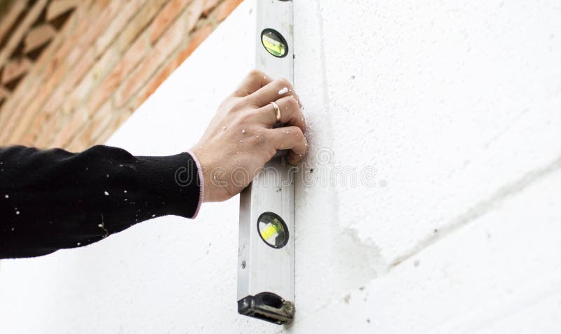 Check Flatness of the Wall Using a Level Stock Photo - Image of walls ...