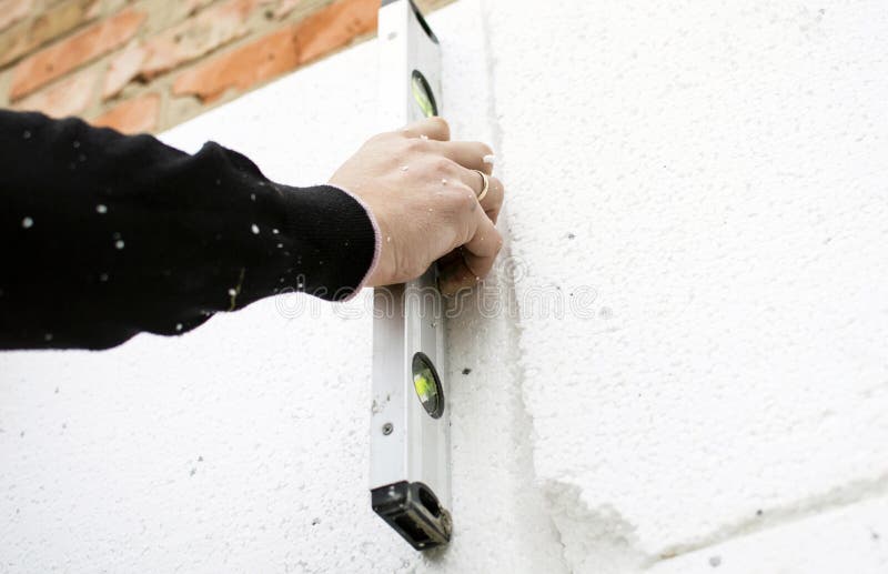 Check Flatness of the Wall Using a Level Stock Photo - Image of ...