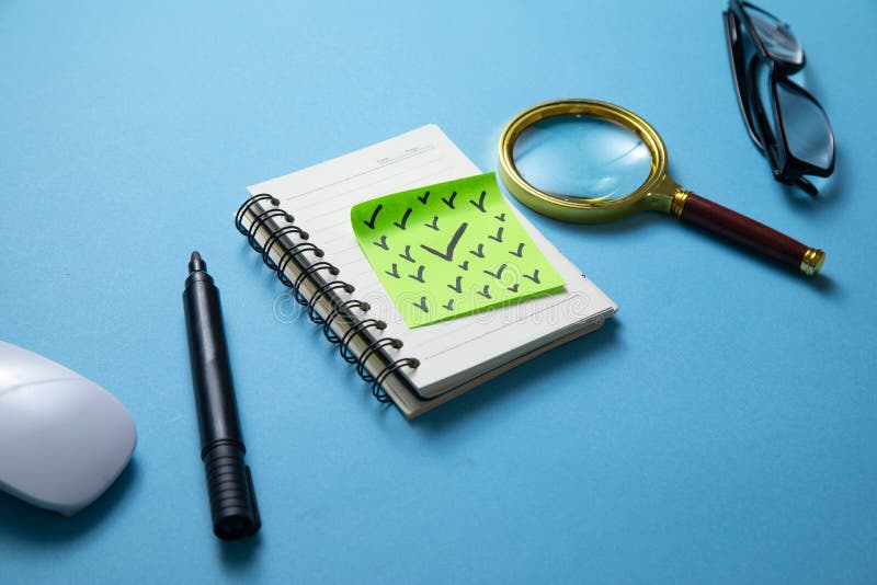 Check Marks on Sticky Note with a Business Objects on the Blue ...
