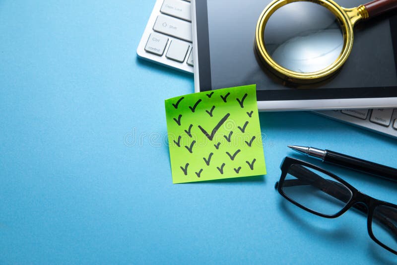 Check Marks on Sticky Note with a Business Objects on the Blue ...