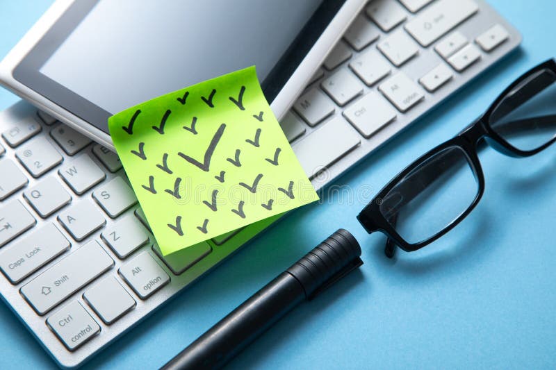 Check Marks on Sticky Note with a Business Objects on the Blue ...