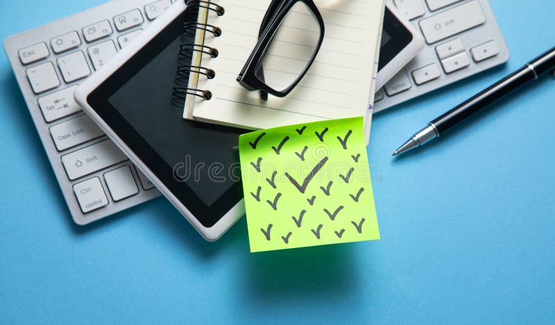 Check Marks on Sticky Note with a Business Objects on the Blue ...