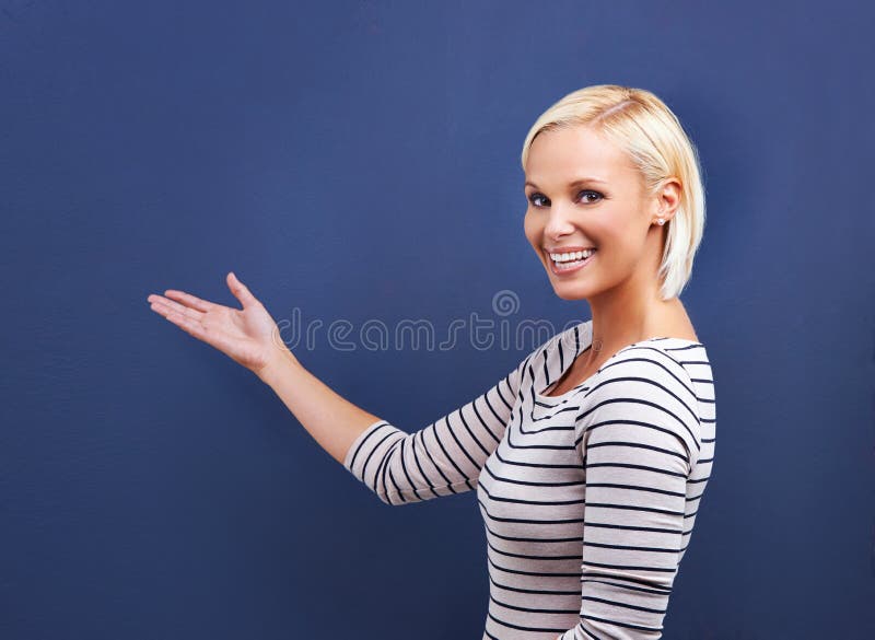 Check this Out. Studio Portrait of a Beautiful Young Woman Presenting ...