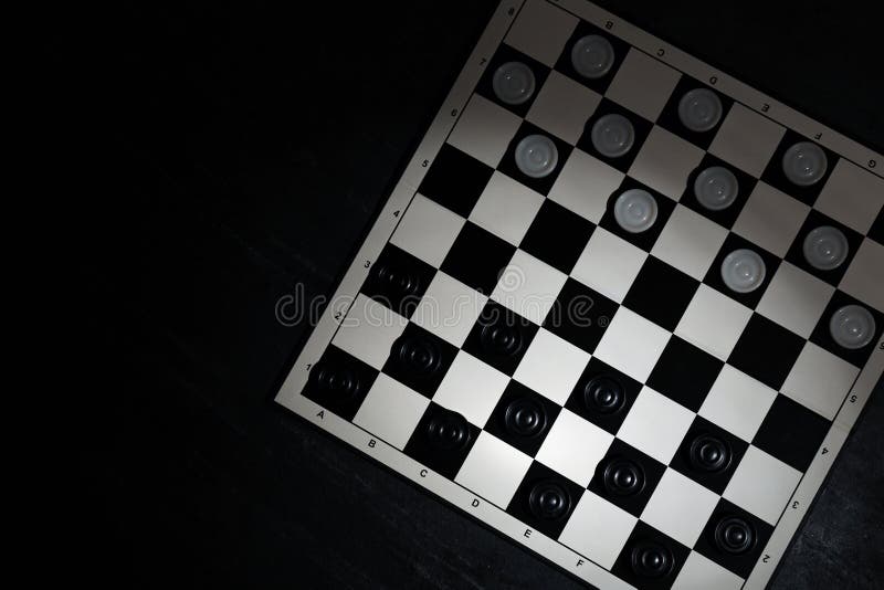 Checkerboard with Game Pieces on Black Table, Top View. Space for Text ...