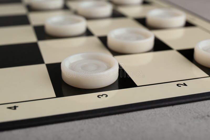 Checkerboard with Game Pieces on Light Grey Table, Closeup Stock Photo ...