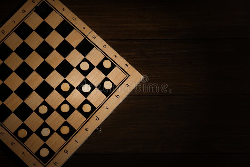 Checkerboard with Game Pieces on Wooden Table, Top View. Space for Text ...