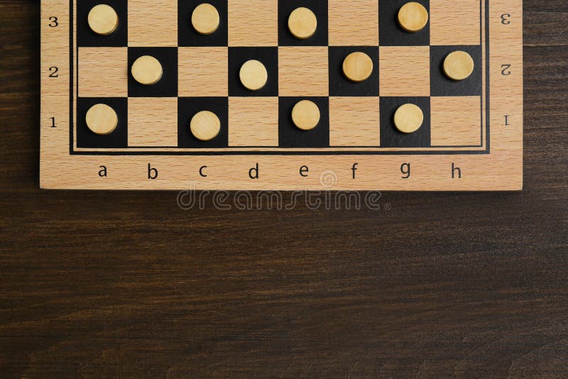 Checkerboard with Game Pieces on Wooden Table, Top View. Space for Text ...