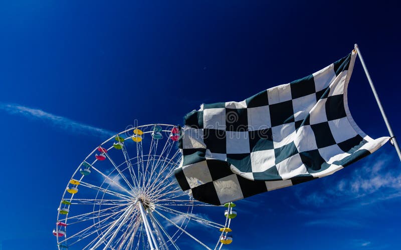 Checkered Flag and Ferris Wheel Against Blue Sky Stock Photo - Image of ...
