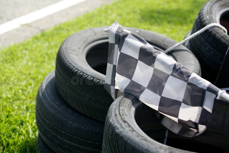 Checkered flag resting stock photo. Image of grass, wheel - 56416546