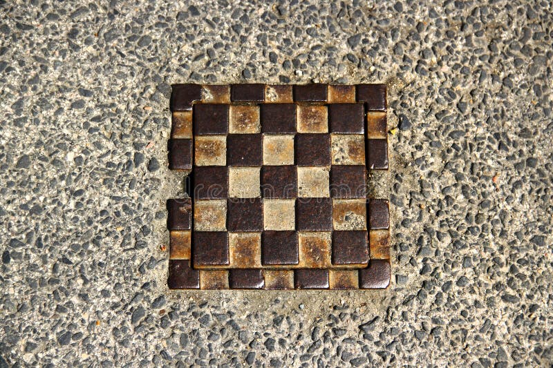 Checkered Manhole Cover on Asphalt Pavement Stock Image - Image of ...