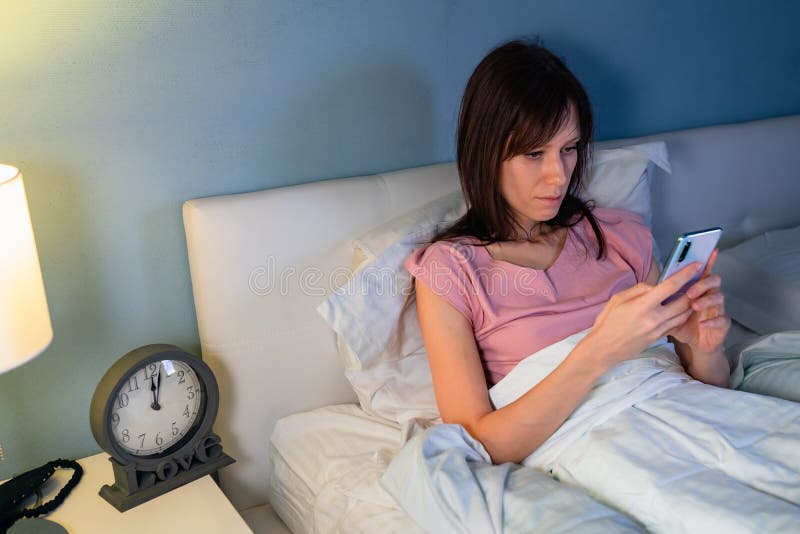Checking Apps before Sleeping - Woman Use Smartphone at Night Stock ...