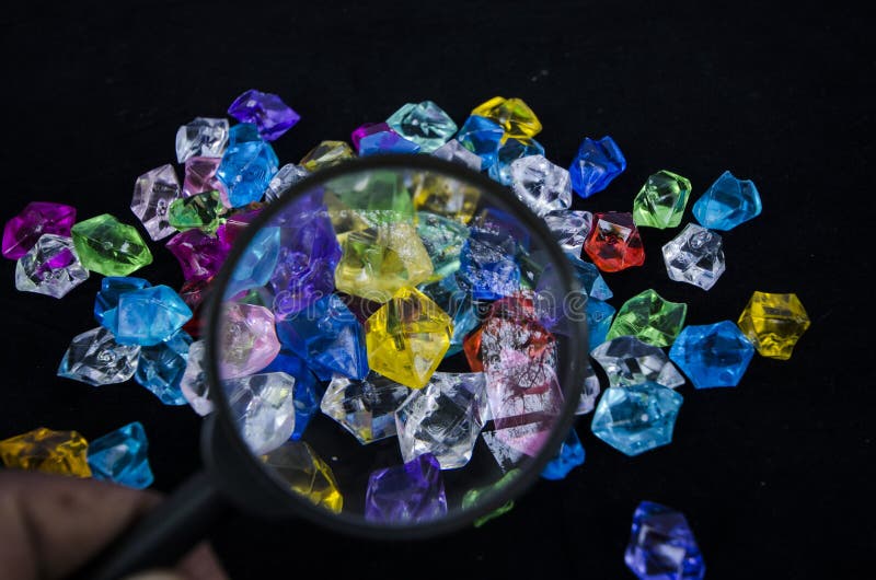 Checking Colored Gems with Magnifying Glass Stock Photo - Image of ...
