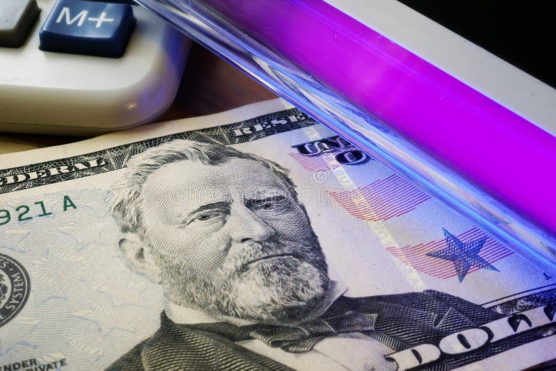 Checking Dollar Banknotes in a UV Light. Stock Image - Image of lamp ...