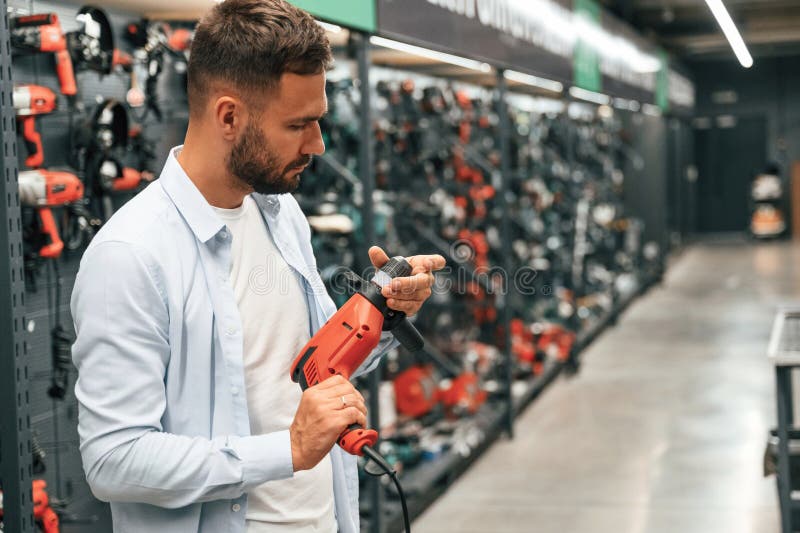 Checking the Drill. Man is in the Hardware Shop Stock Illustration ...