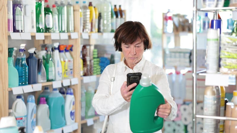 Checking Expiration Date of Detergent - Male Shopper Scans QR Code on Label of Detergent Using ...