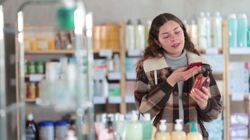 Checking Expiration Date of Liquid Hand Soap - Female Shopper in Winter ...