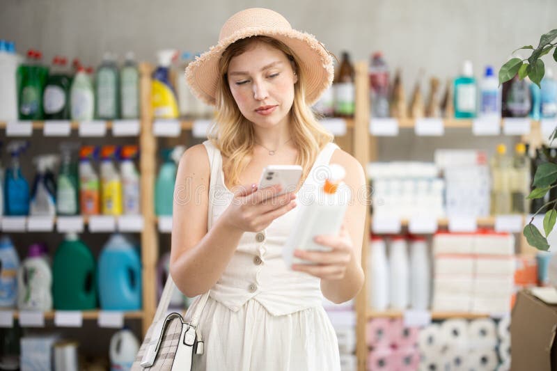 Checking Expiration Date of Shampoo or Shower Gel - Female Shopper Scans QR Code on Label of ...