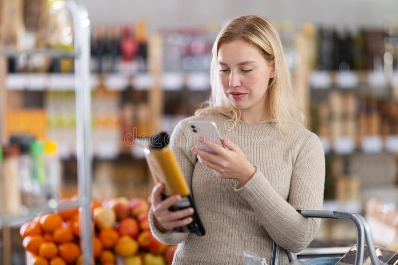 Checking Expiration Date of Spaghetti - Female Shopper Scans QR Code on Label of Spaghetti Using ...