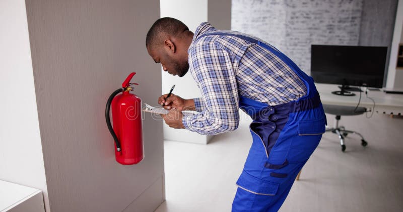 Checking Fire Extinguisher stock photo. Image of checking - 268250162