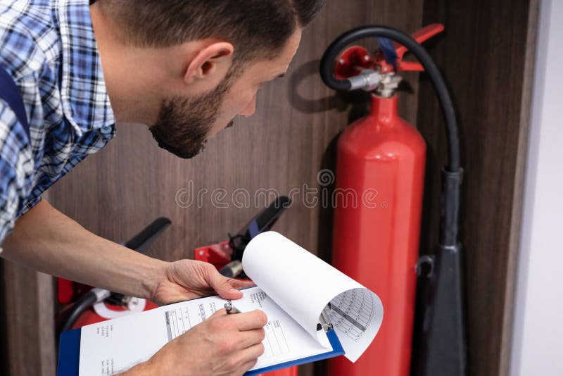 Checking Fire Extinguisher. Safety Stock Image - Image of indoor ...