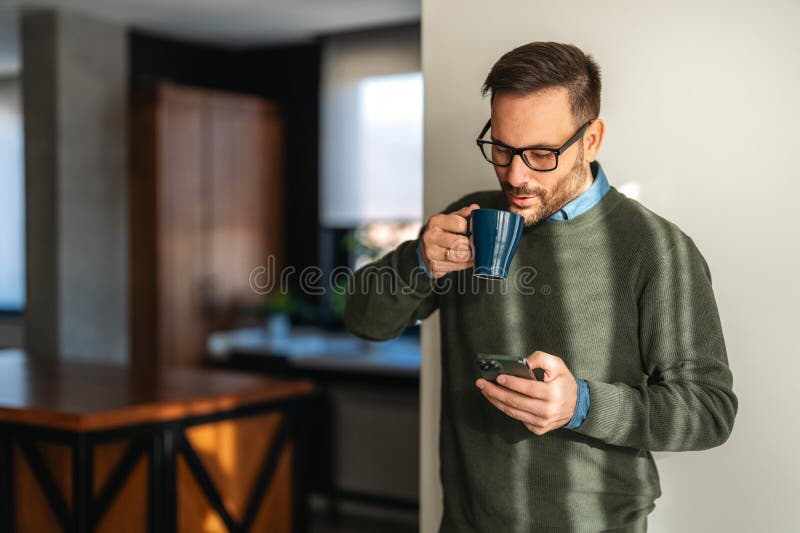 Checking His Messages Over Coffee. Man Using a Smart Phone while ...