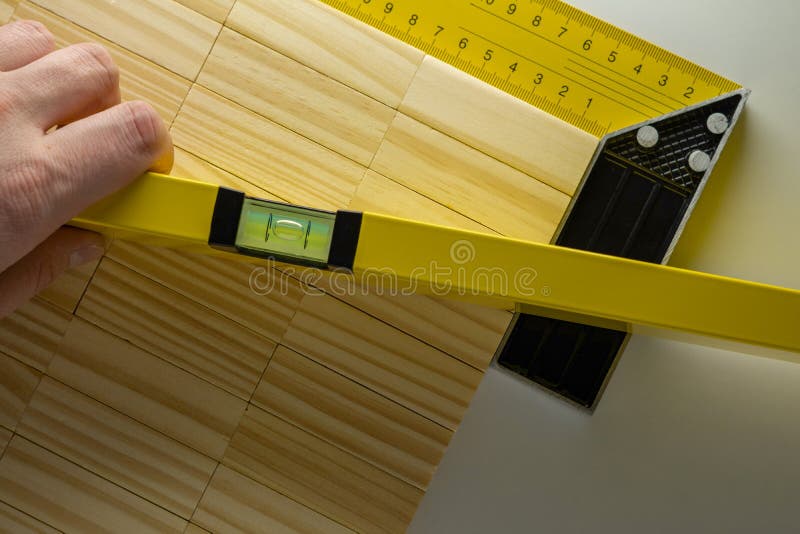 Checking the Level of the Table, Hand with Building Level or Waterpas ...