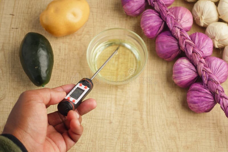 Checking Oil Temperature for Cooking Stock Photo - Image of delicious ...