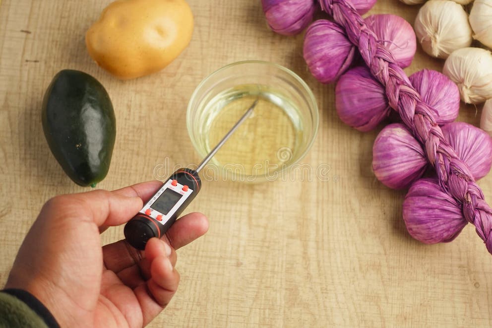 Checking Oil Temperature for Cooking Stock Photo - Image of delicious ...